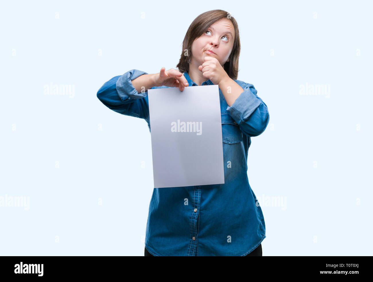 Young adult woman with down syndrome holding blank paper sheet over ...