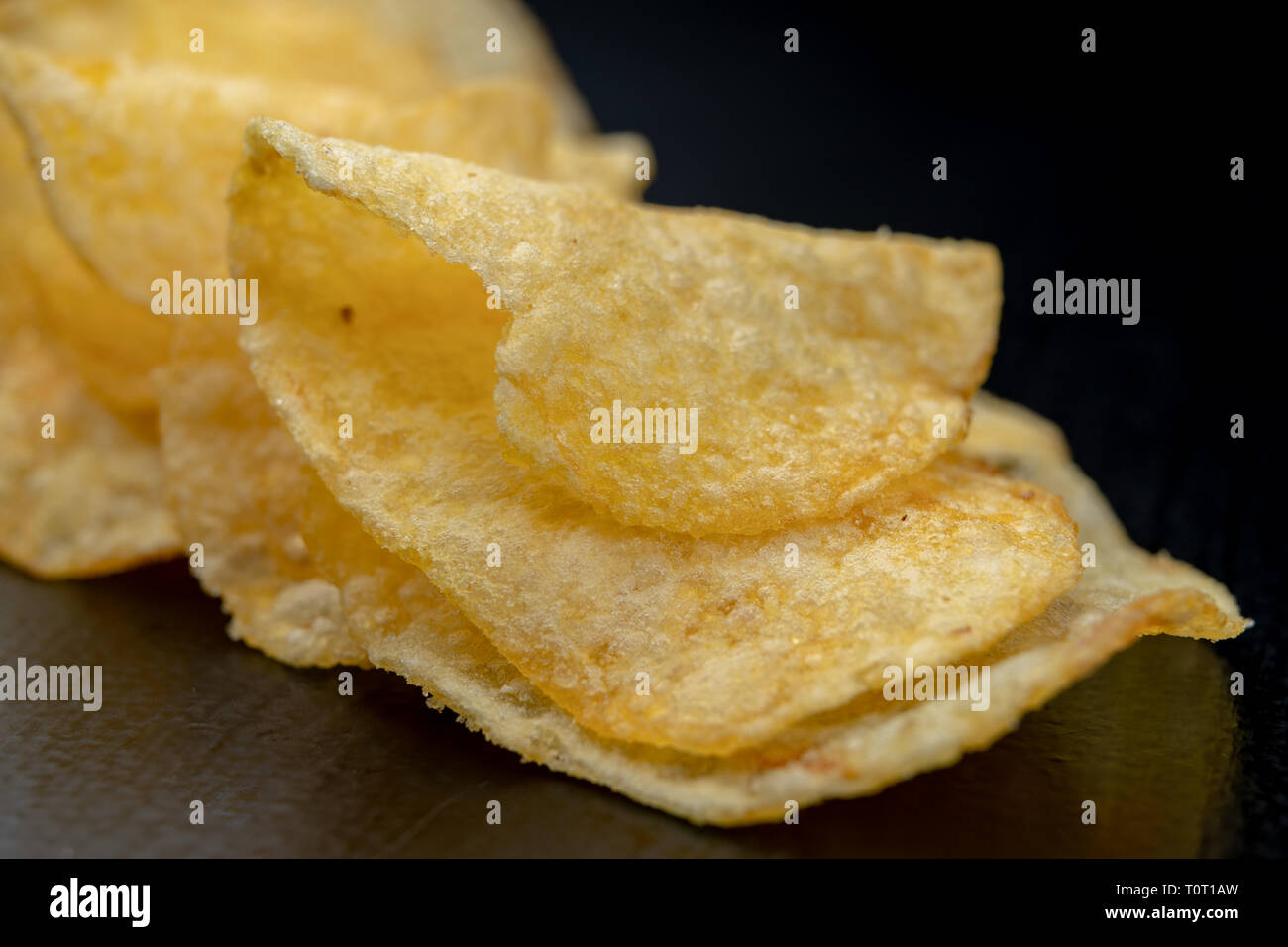 Tasty crisps on the kitchen table. Salty snacks as an addition to beer ...