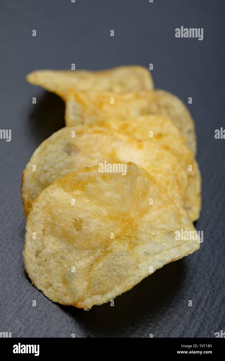 Tasty crisps on the kitchen table. Salty snacks as an addition to beer ...