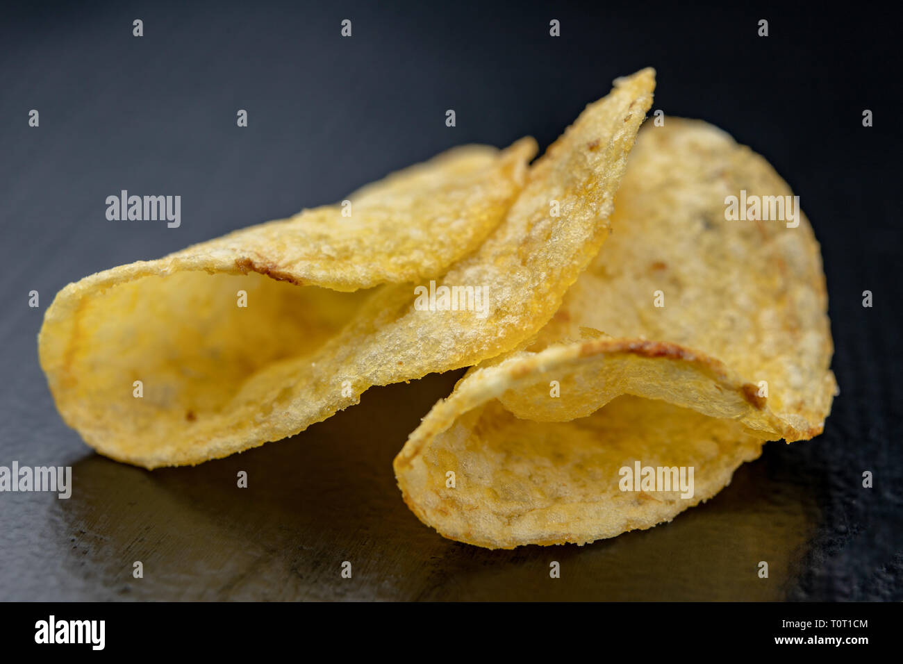 Tasty crisps on the kitchen table. Salty snacks as an addition to beer ...