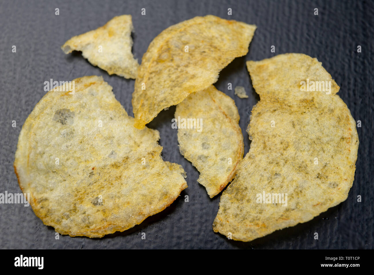Tasty crisps on the kitchen table. Salty snacks as an addition to beer ...