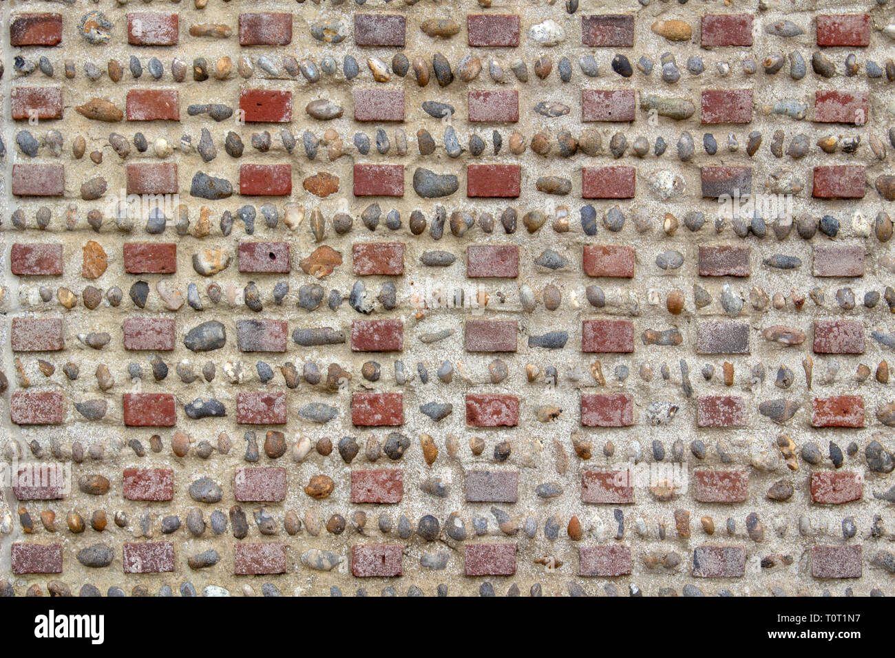 Close-up image of a brick and pebble wall Stock Photo - Alamy