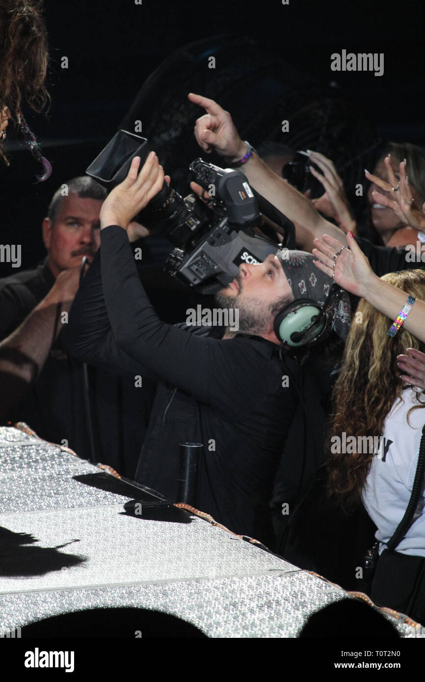 A camera man is shown taping and protecting a "live" concert ...