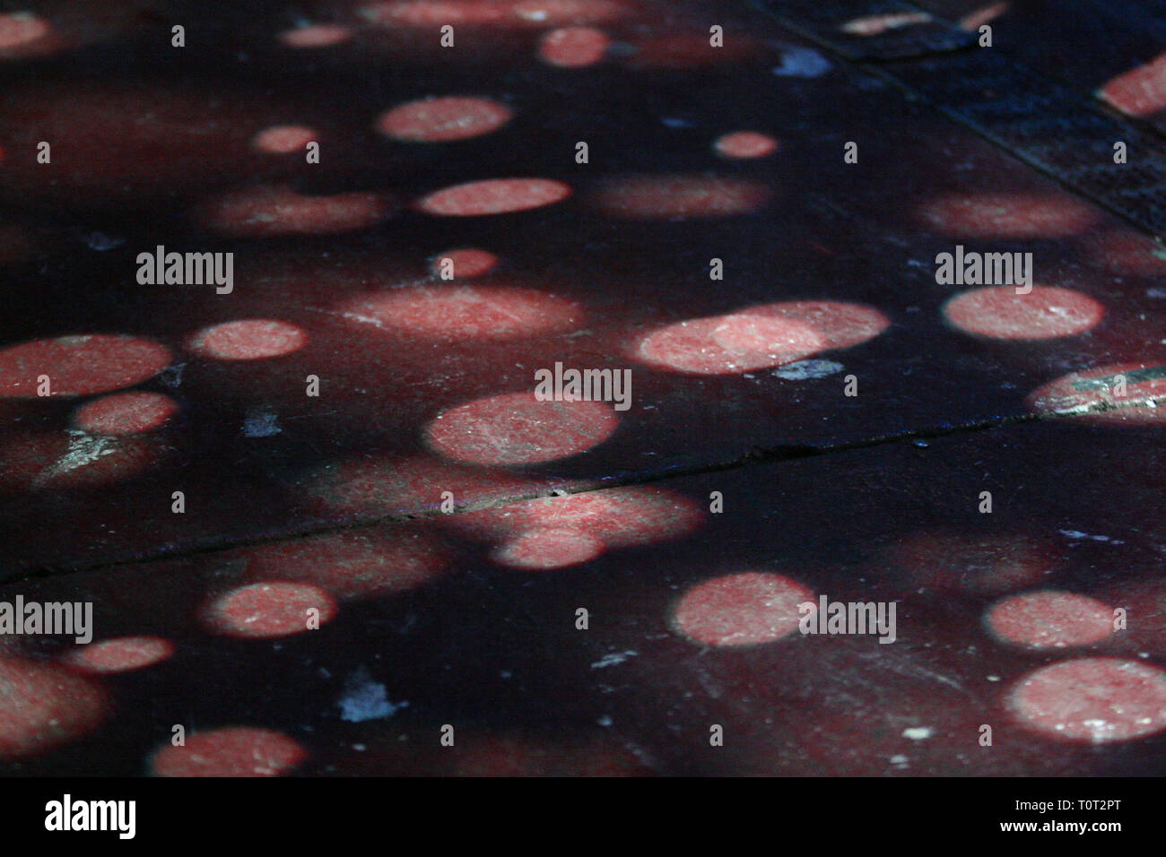 Circular lighting effects are shown reflected on the floor during a ...