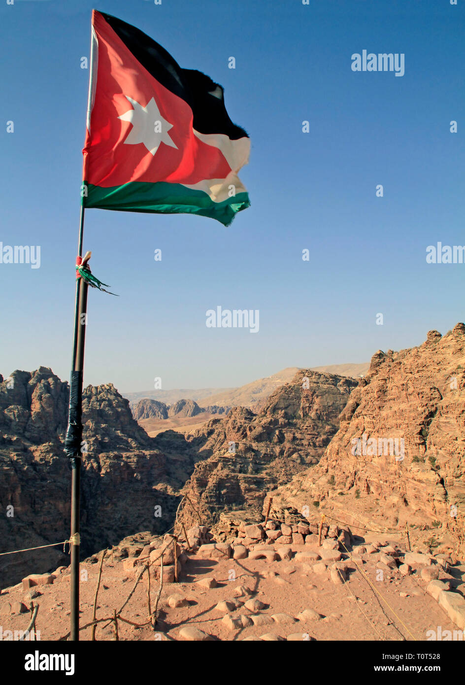 National flag of Jordan in the rugged landscape of Petra, Jordan Stock ...