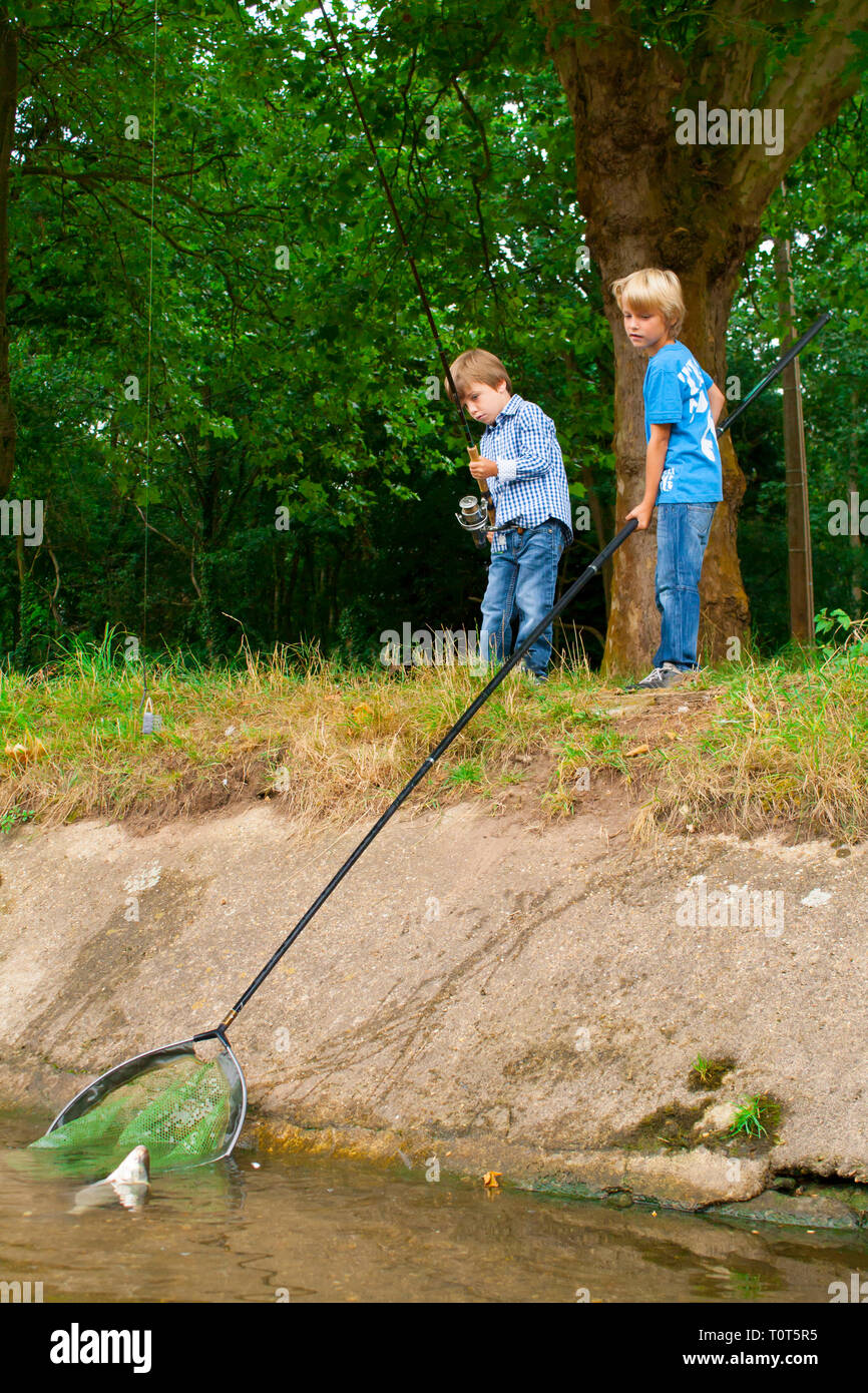 Boys catching fish hi-res stock photography and images - Alamy