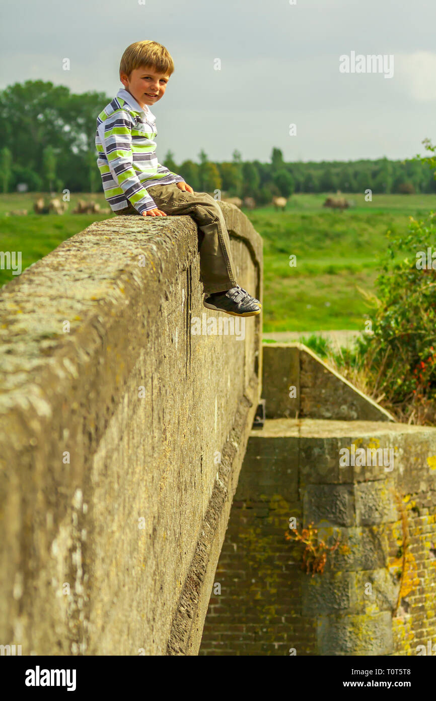 Boy sitting on concrete hi-res stock photography and images - Alamy