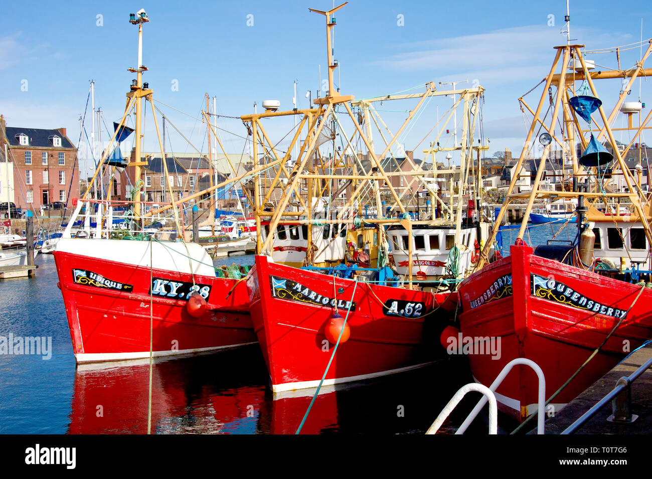 Three red fishing boats, the Ubique, the Marigold and the Queensberry ...
