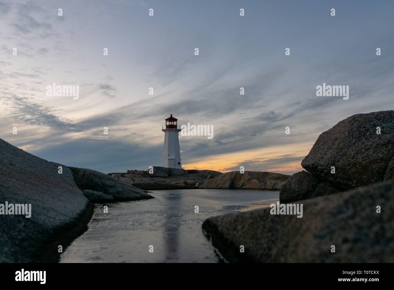lighthouse at sunset behind frozen pond Stock Photo - Alamy