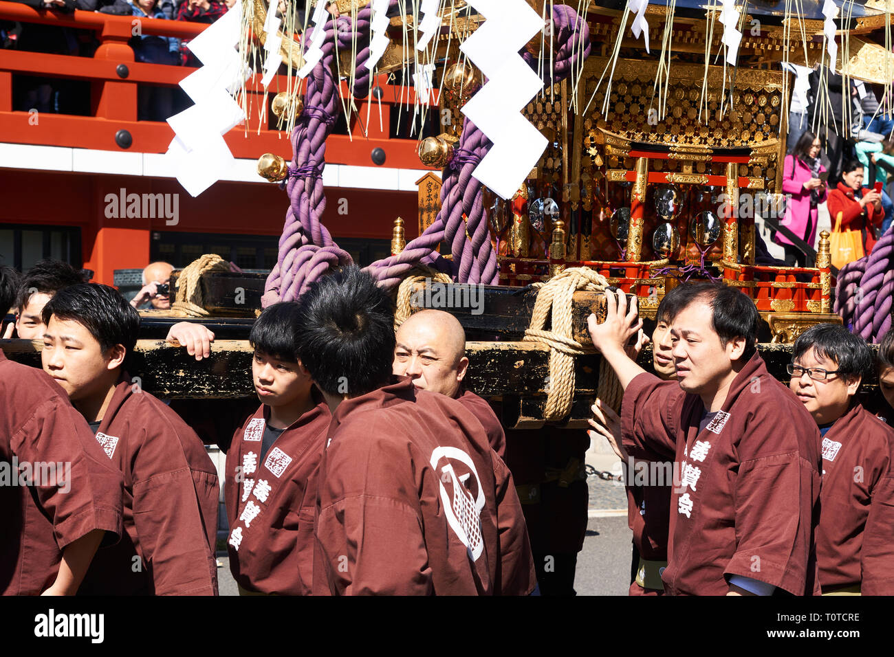People carry the mikoshi (portable shrine housing the kami or god) at ...