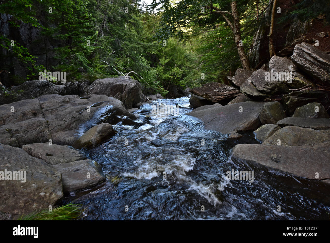 waterfall running through rocks Stock Photo - Alamy