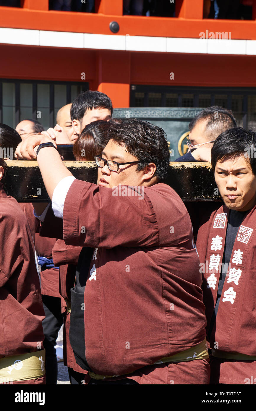 Men carry the mikoshi (portable shrine housing the kami or god) at ...