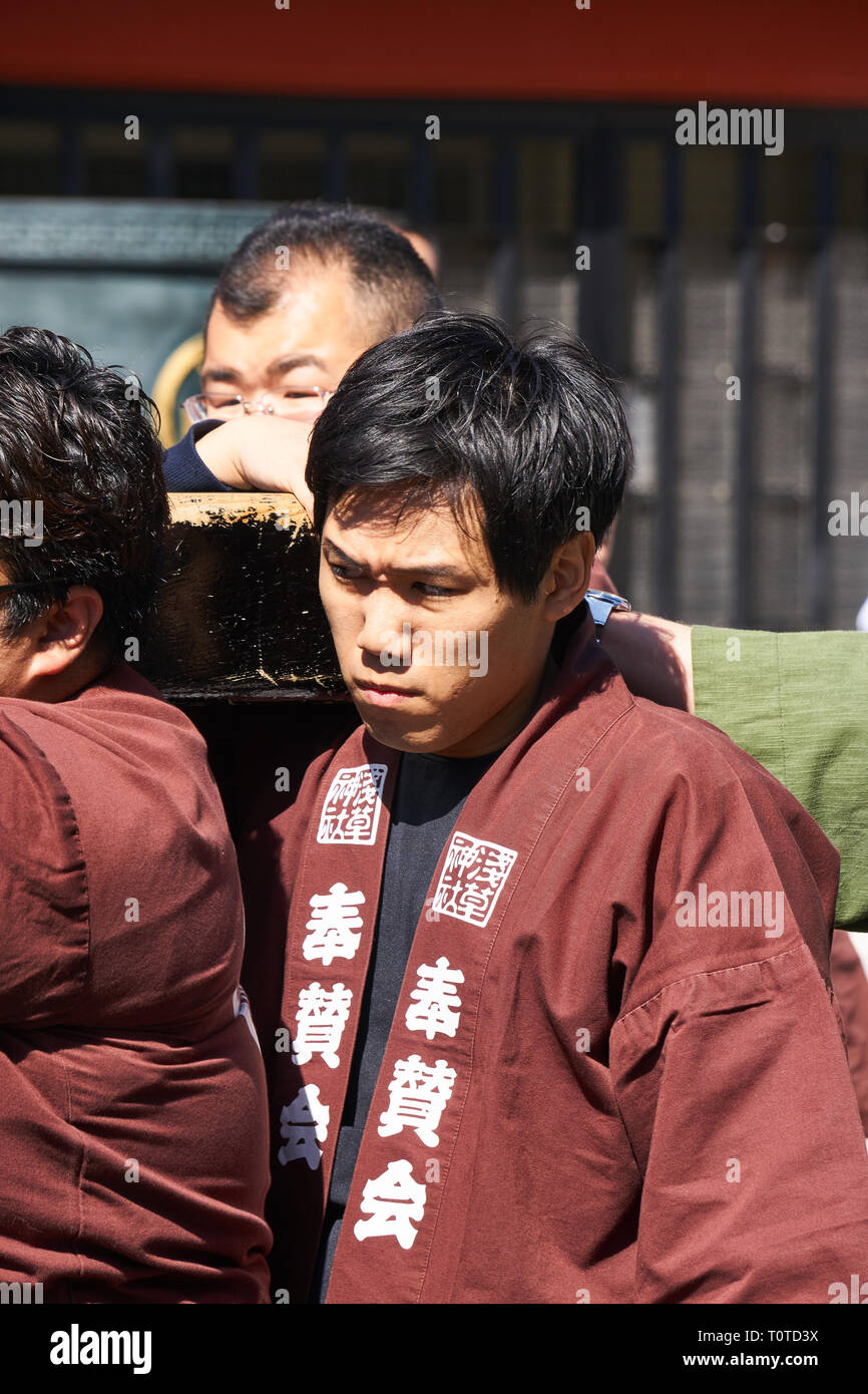 Men carry the mikoshi (portable shrine housing the kami or god) at ...