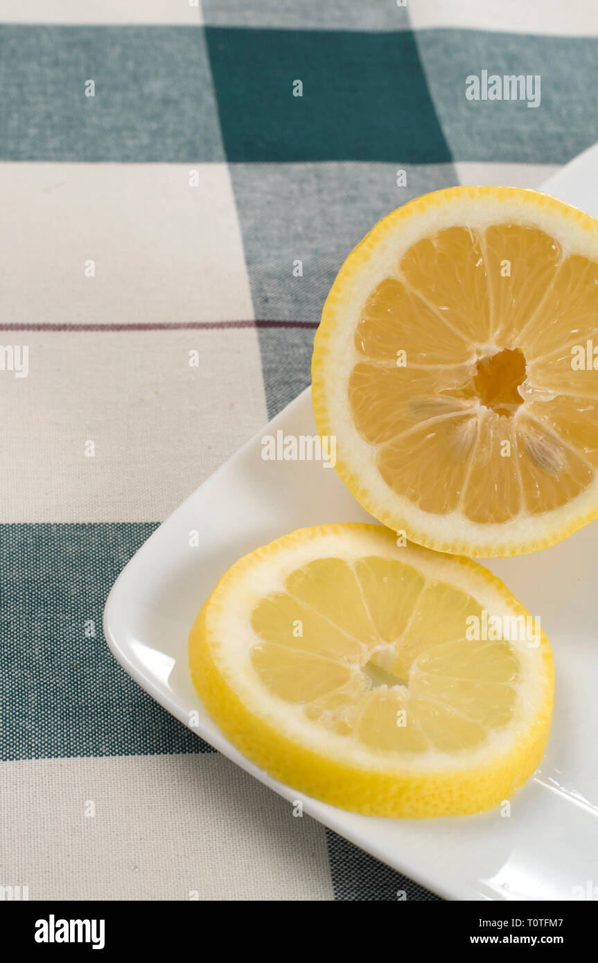 Delicious Fresh Lemon slices in a White Plate Stock Photo - Alamy