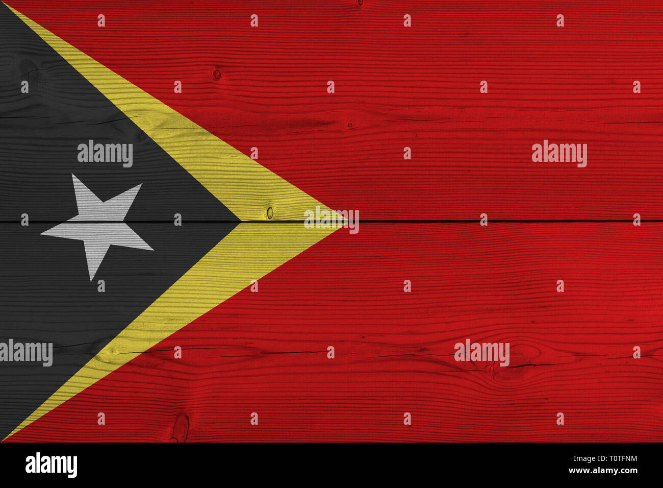 East Timor flag painted on old wood plank. Patriotic background ...
