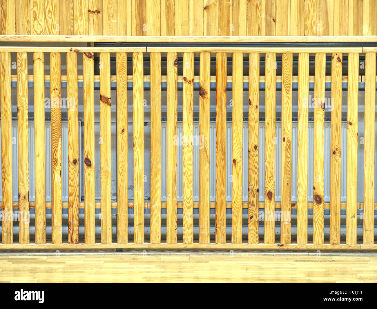 Heating radiator on wall with wooden ribs row cover, construction of ...