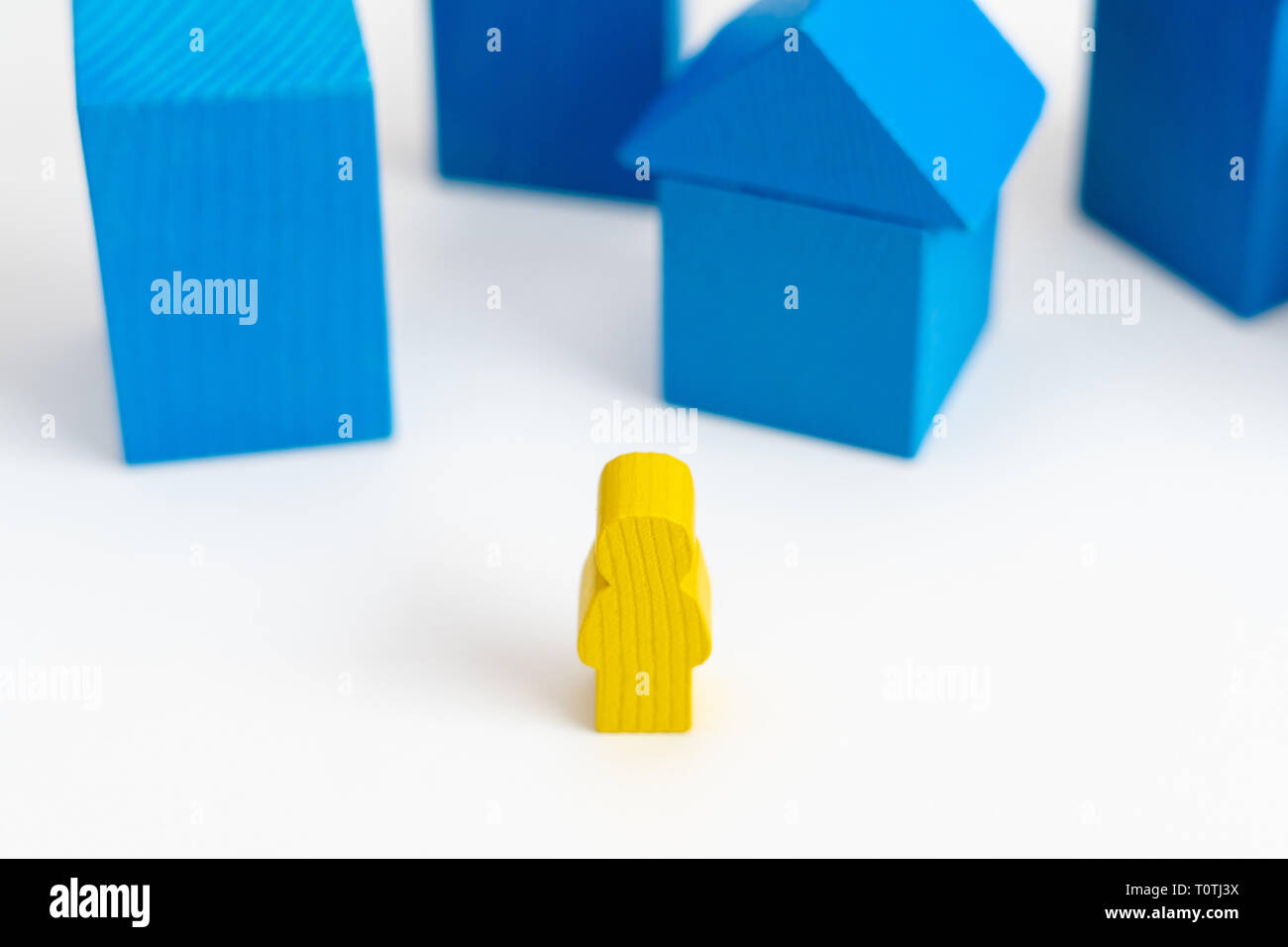 Wooden person on the street of City with wooden blocks houses on the ...
