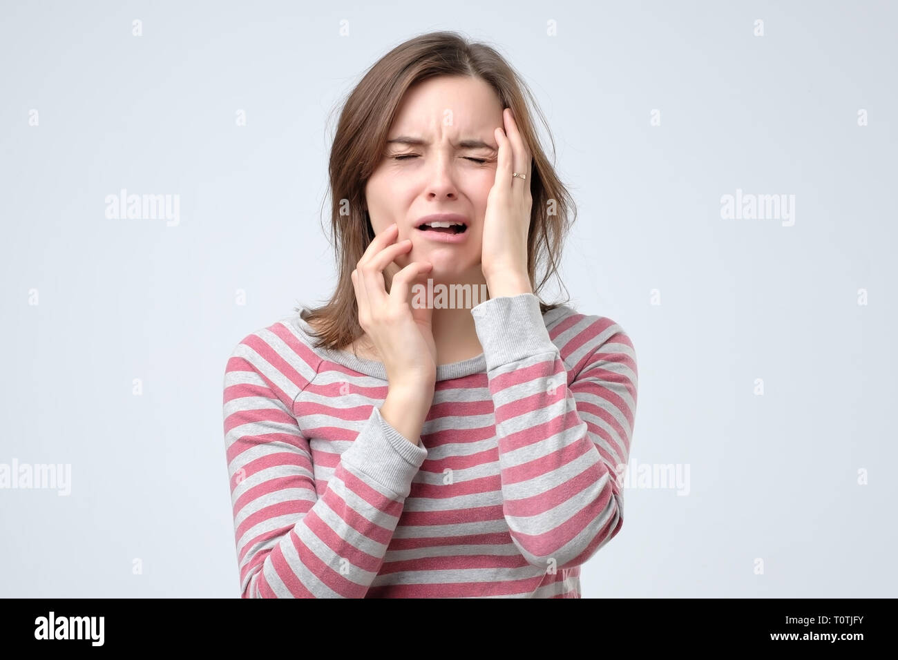 Portrait of a worried woman. Isolated white background Stock Photo - Alamy