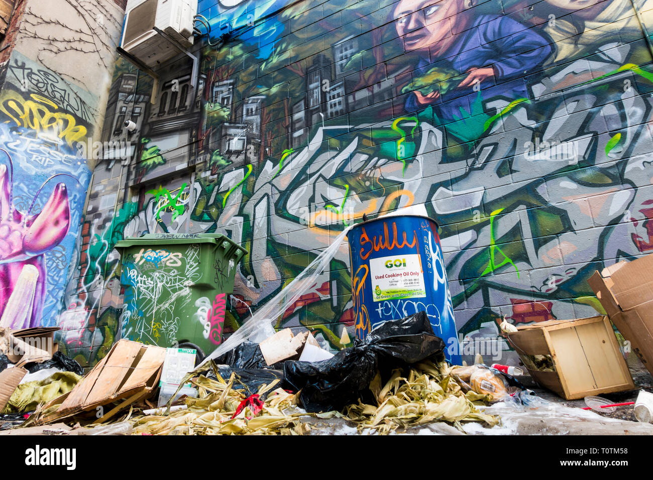 Garbage in graffiti alley featuring a large number of colourful wall ...