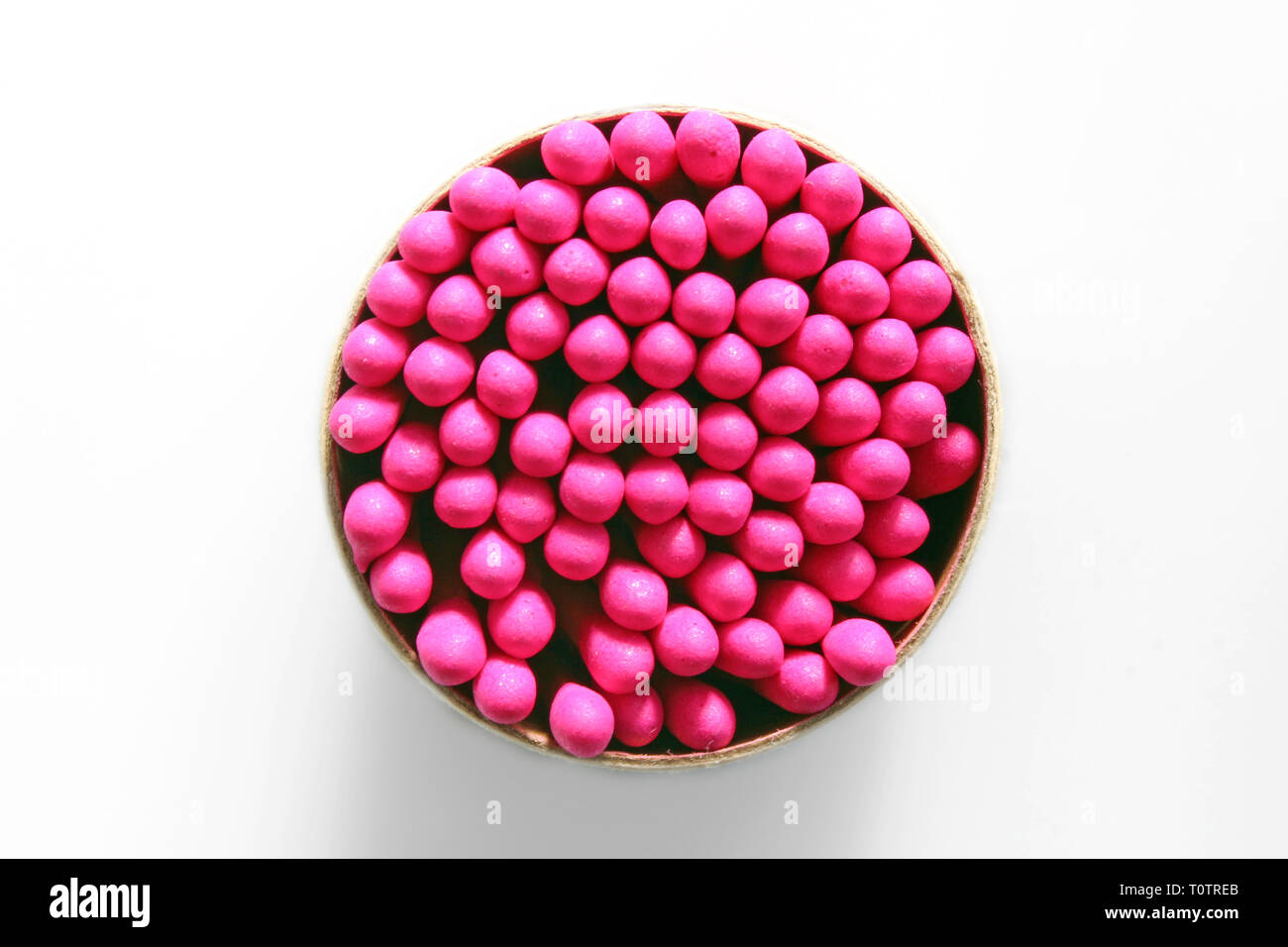 Overhead shot of a bunch of pink-tipped matchsticks, isolated on white ...