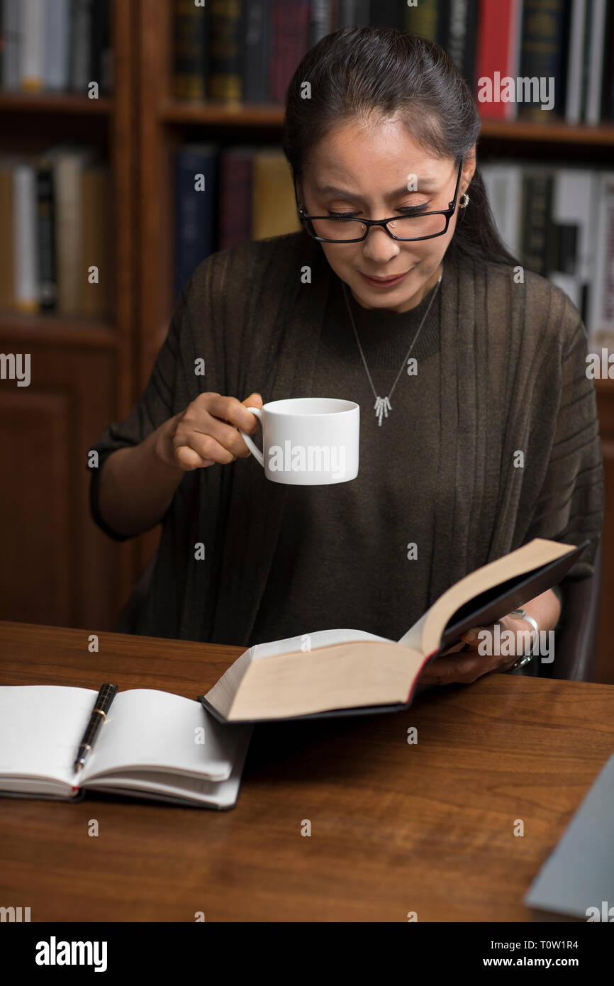 Serious chinese woman reading hi-res stock photography and images - Alamy