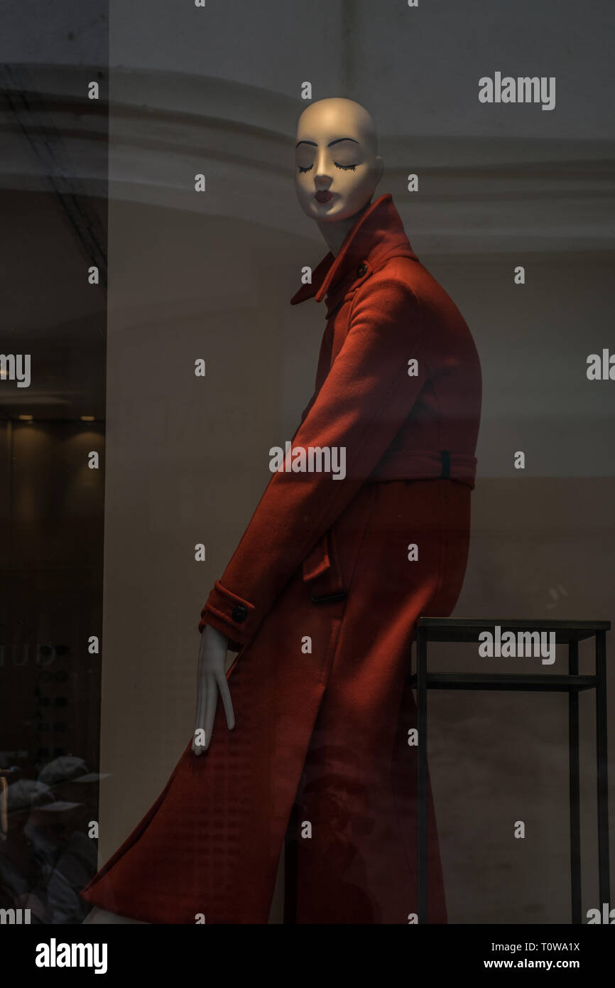 Elegant bold dummy dressed with a red coat Stock Photo - Alamy
