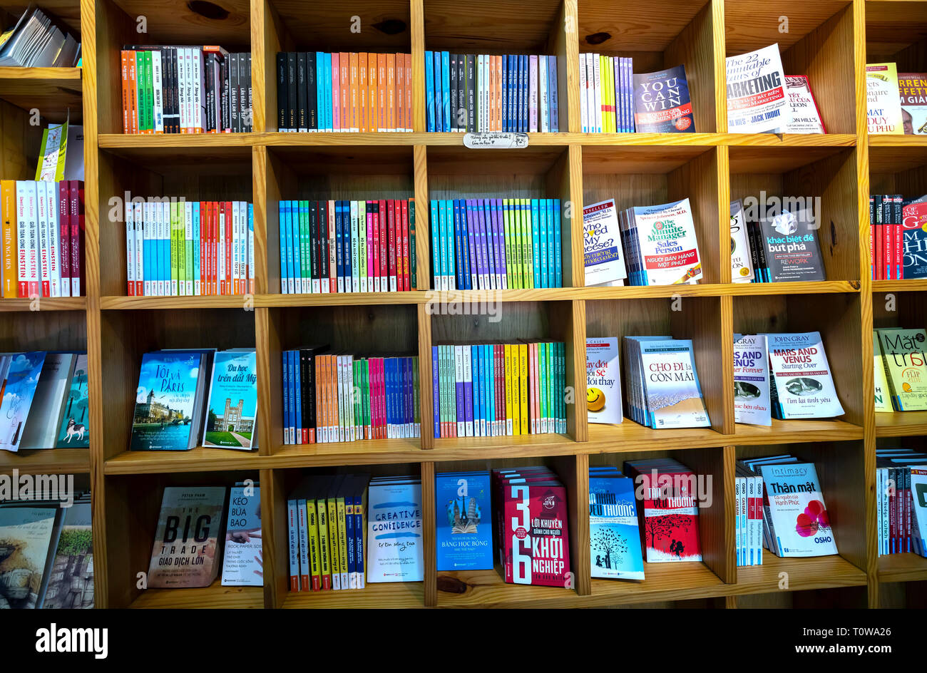 Colorful book shelves packed with books in a library Stock Photo - Alamy