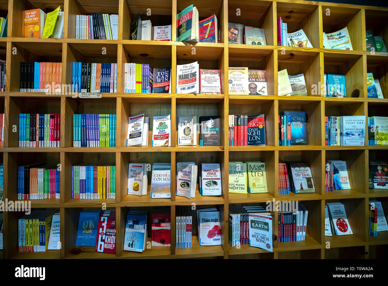 Colorful book shelves packed with books in a library Stock Photo - Alamy
