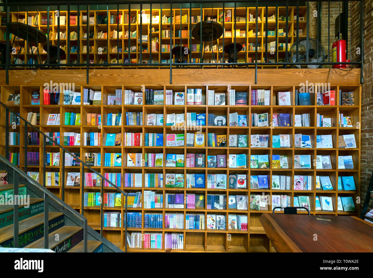 Colorful book shelves packed with books in a library Stock Photo - Alamy