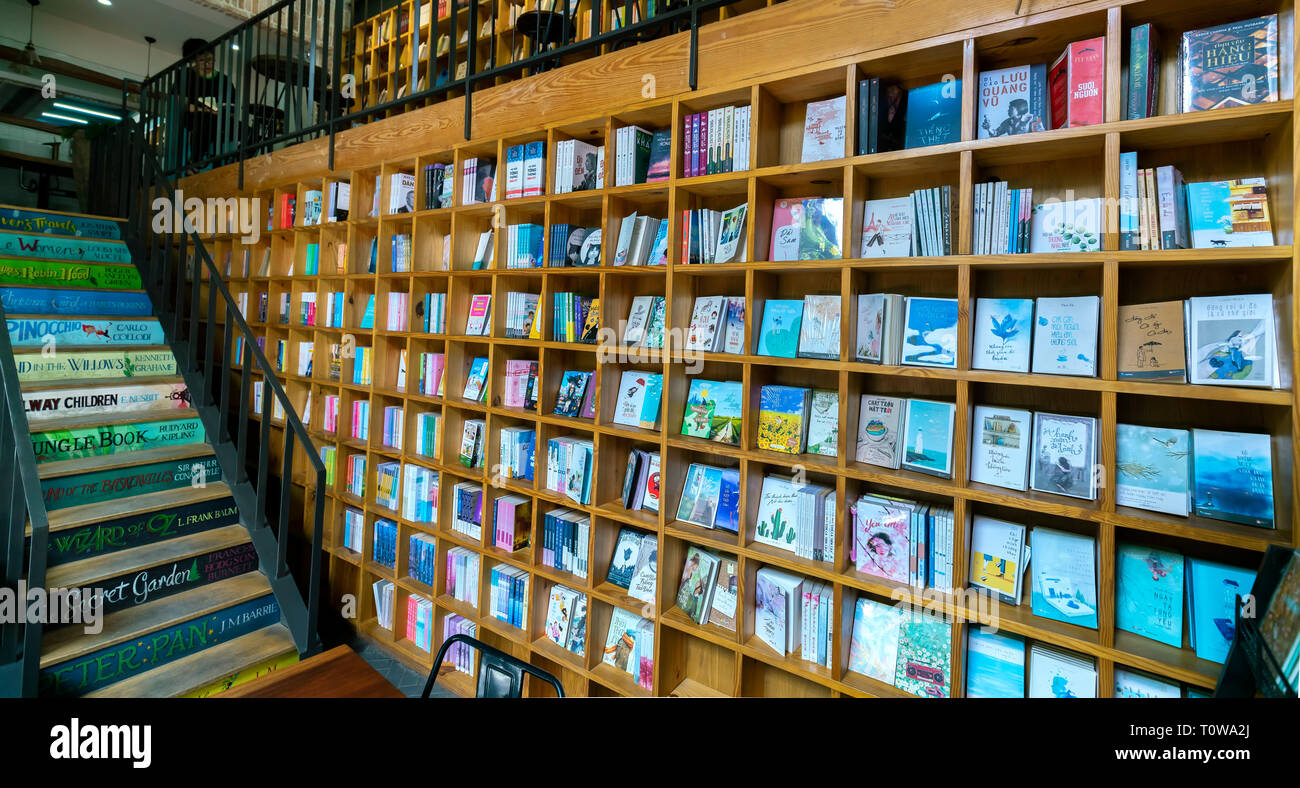 Colorful book shelves packed with books in a library. This is an ...