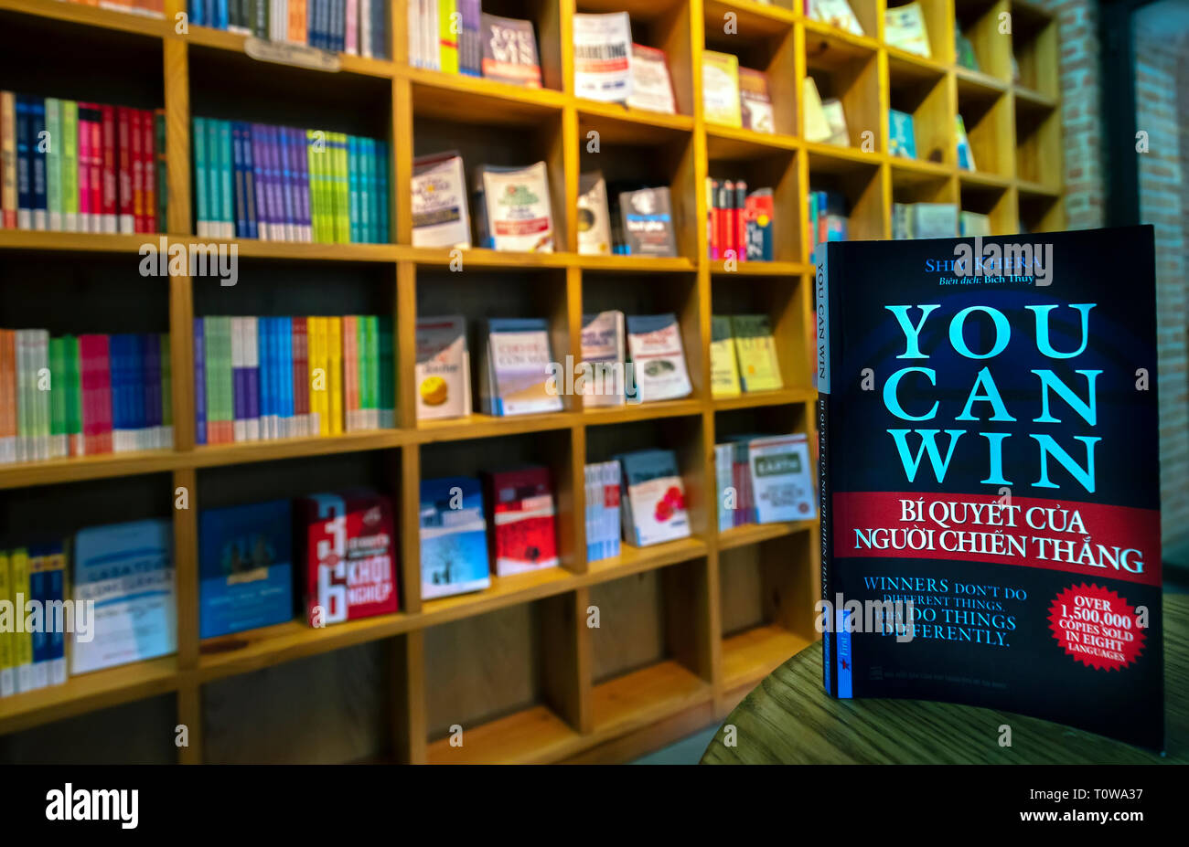 Colorful book shelves packed with books in a library. This is an ...