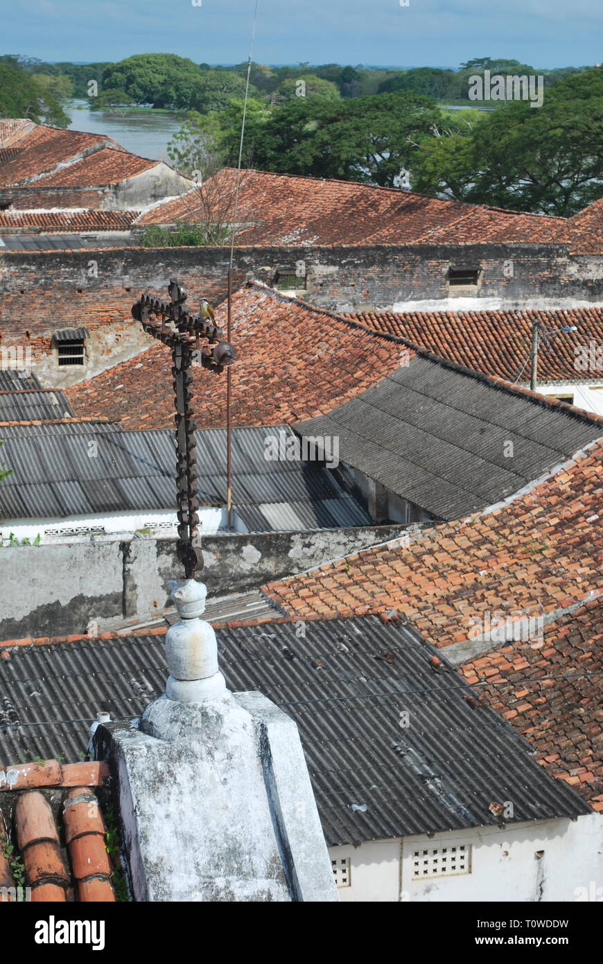 View across rooftops with metal cross Stock Photo - Alamy