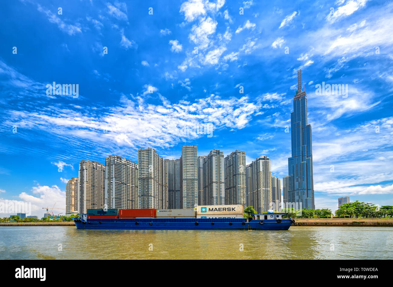 Skyscrapers viewed from riverside with dramatic sky showing urban ...