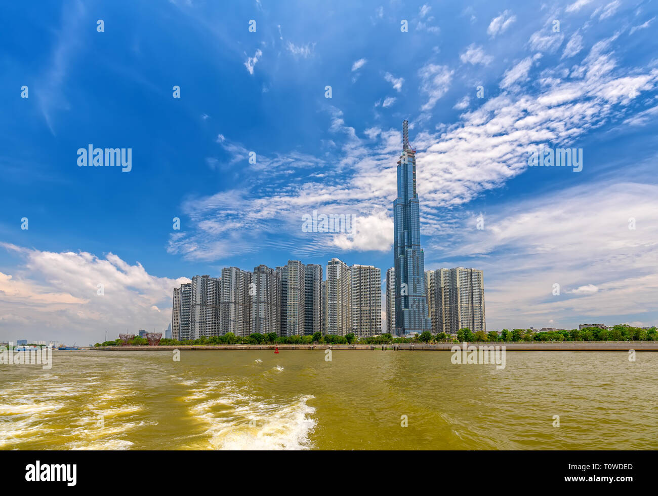 Skyscrapers viewed from riverside with dramatic sky showing urban ...