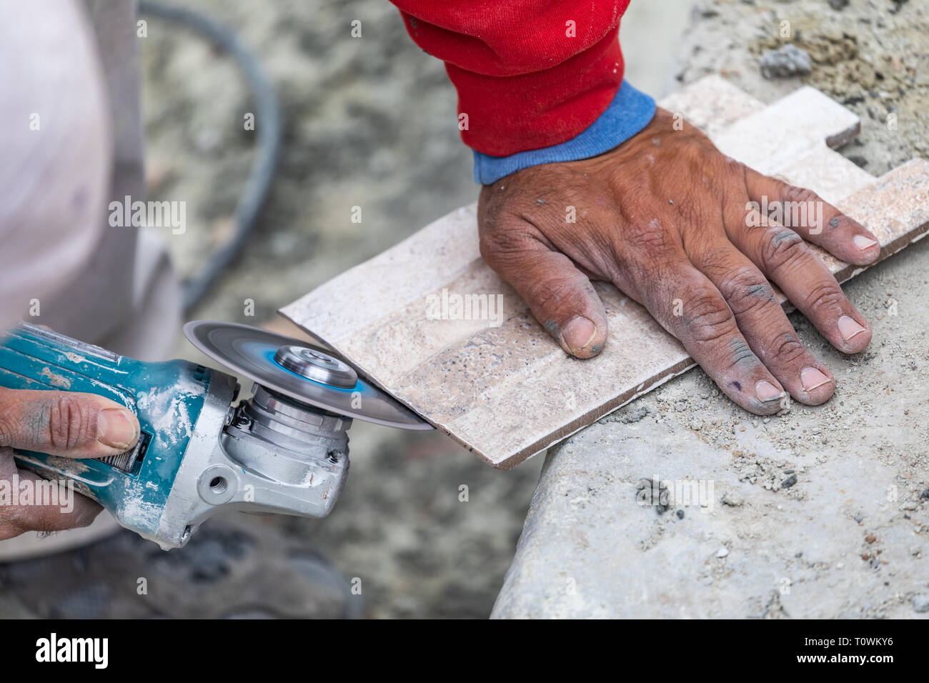 Worker Grinding Corner Tile for Fitting Stock Photo - Alamy