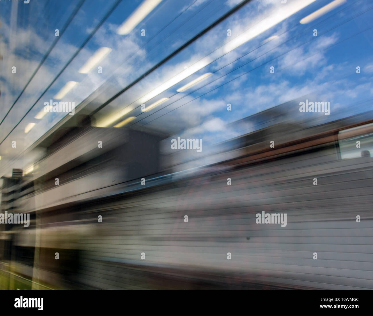 a view out from the window of a train. The industrial area is running ...