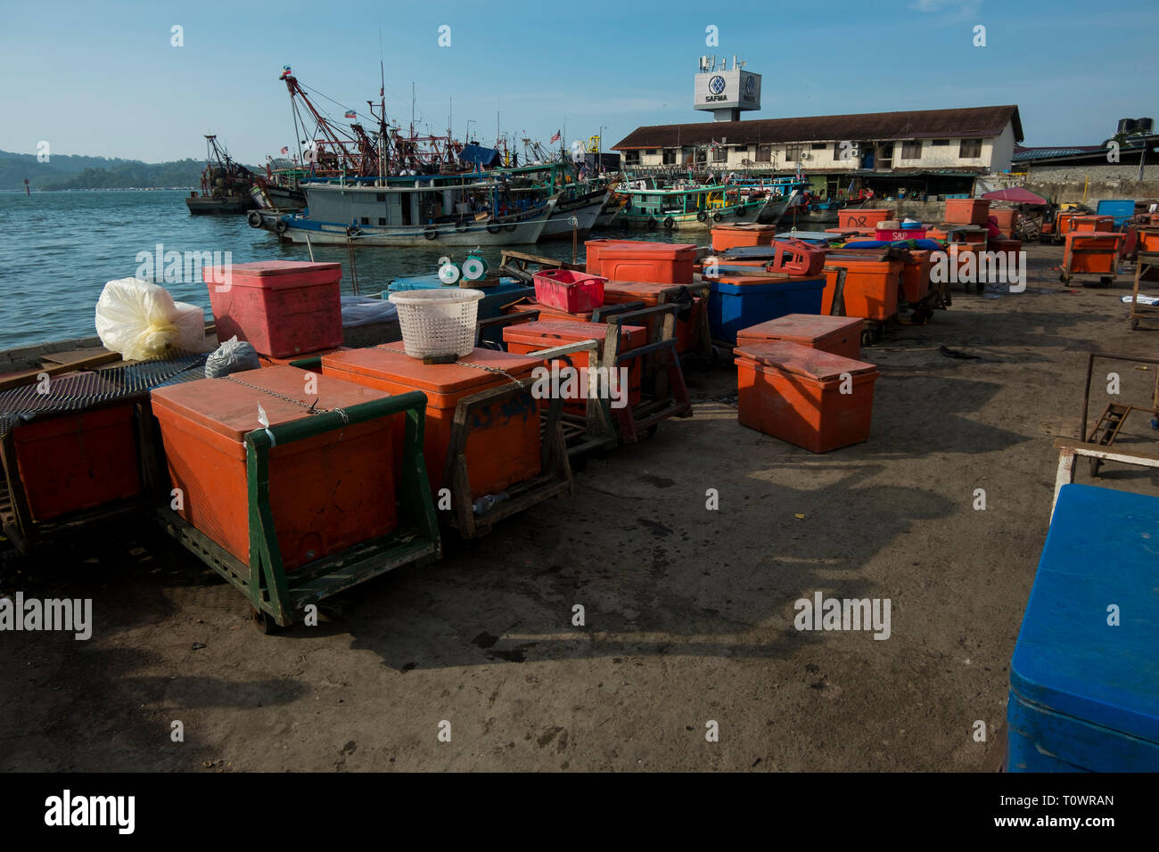 Huge orange and blue coolers sit ready to load up on fresh fish ...