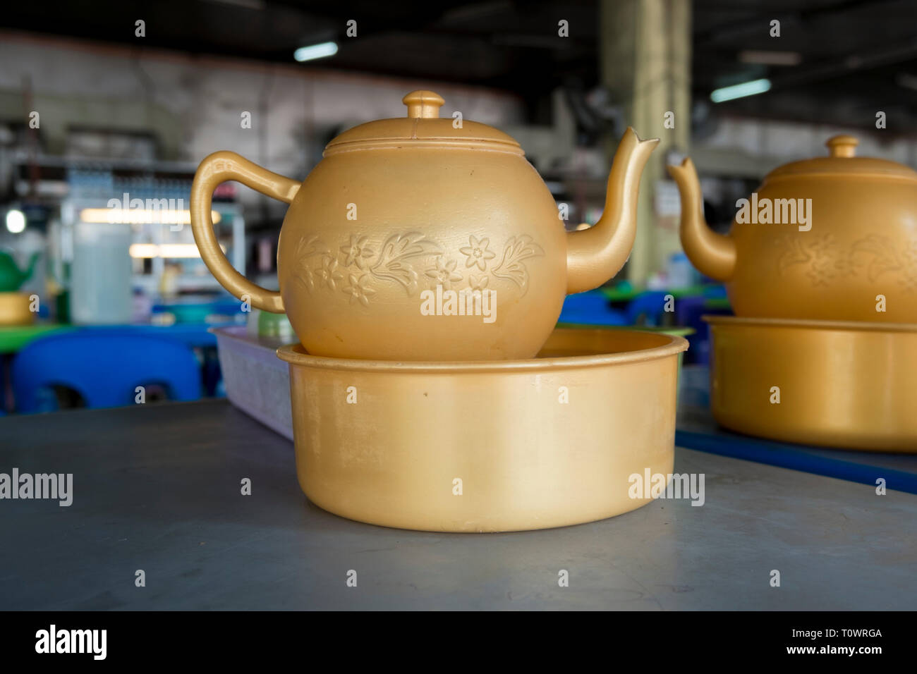 A gold, plastic hand washing set at a cafe table in Kota Kinabalu ...