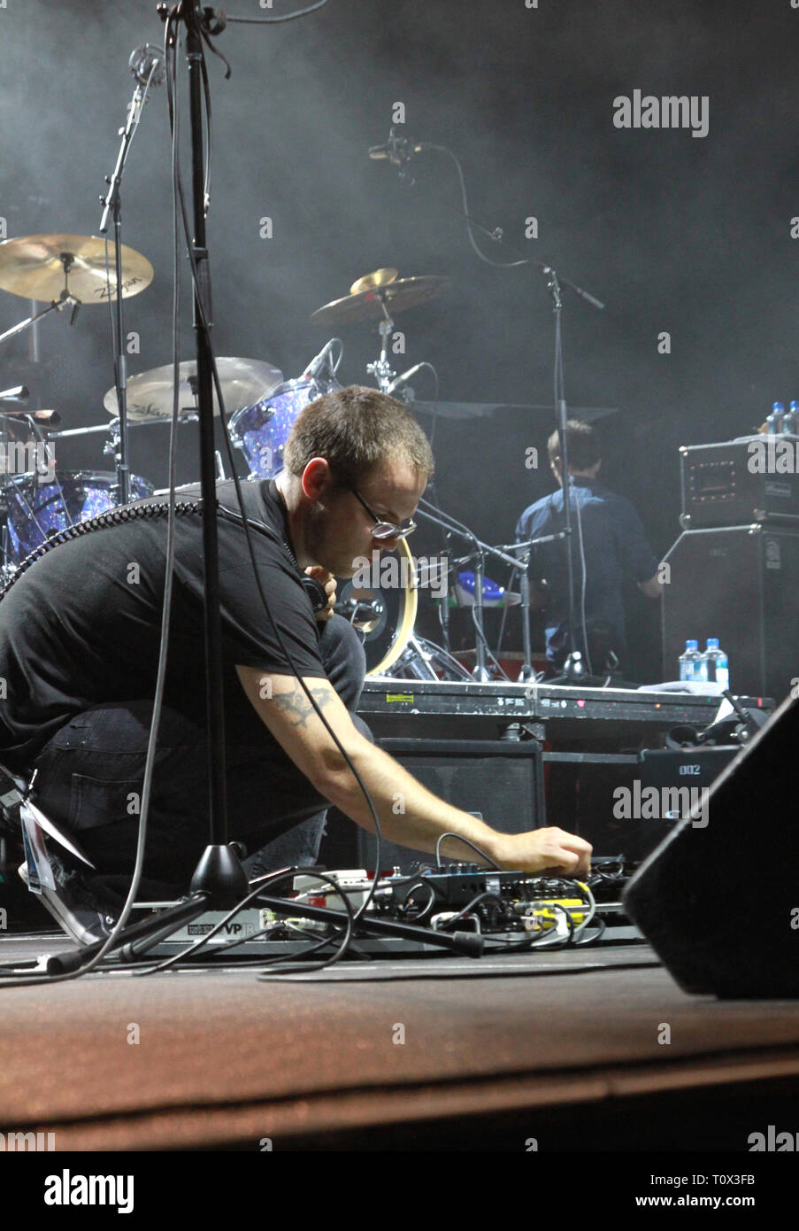 A guitar technician is shown setting up and making adjustments to ...
