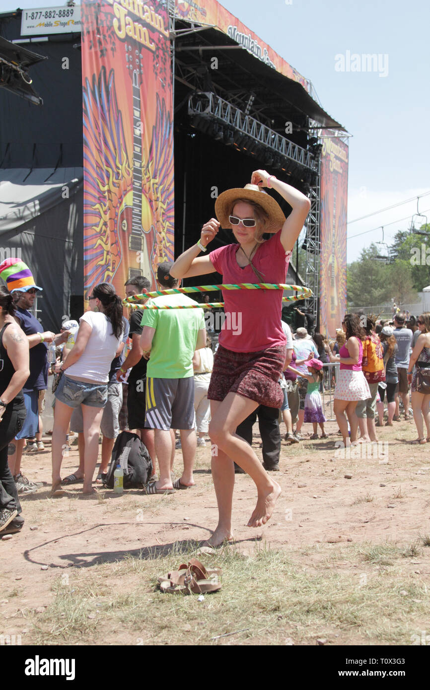 A concert fan is shown having fun with a hole hoop during the Mountain ...