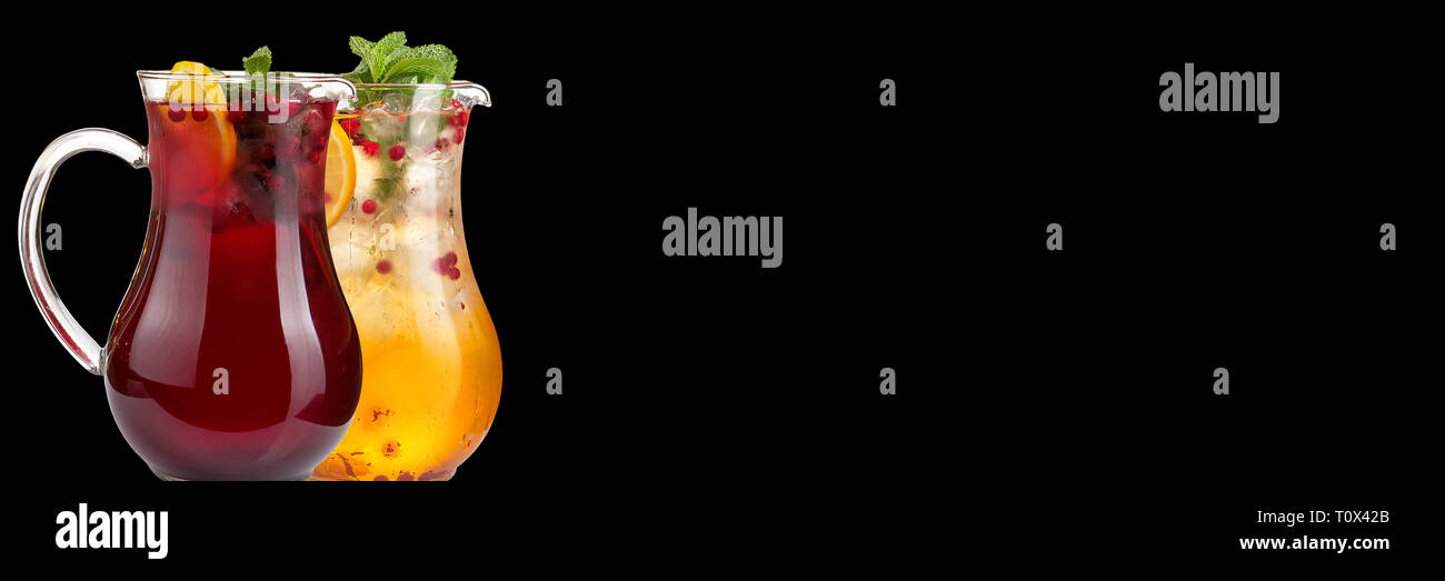 Cocktails in glass carafes with orange and berries sweet syrup and mint ...