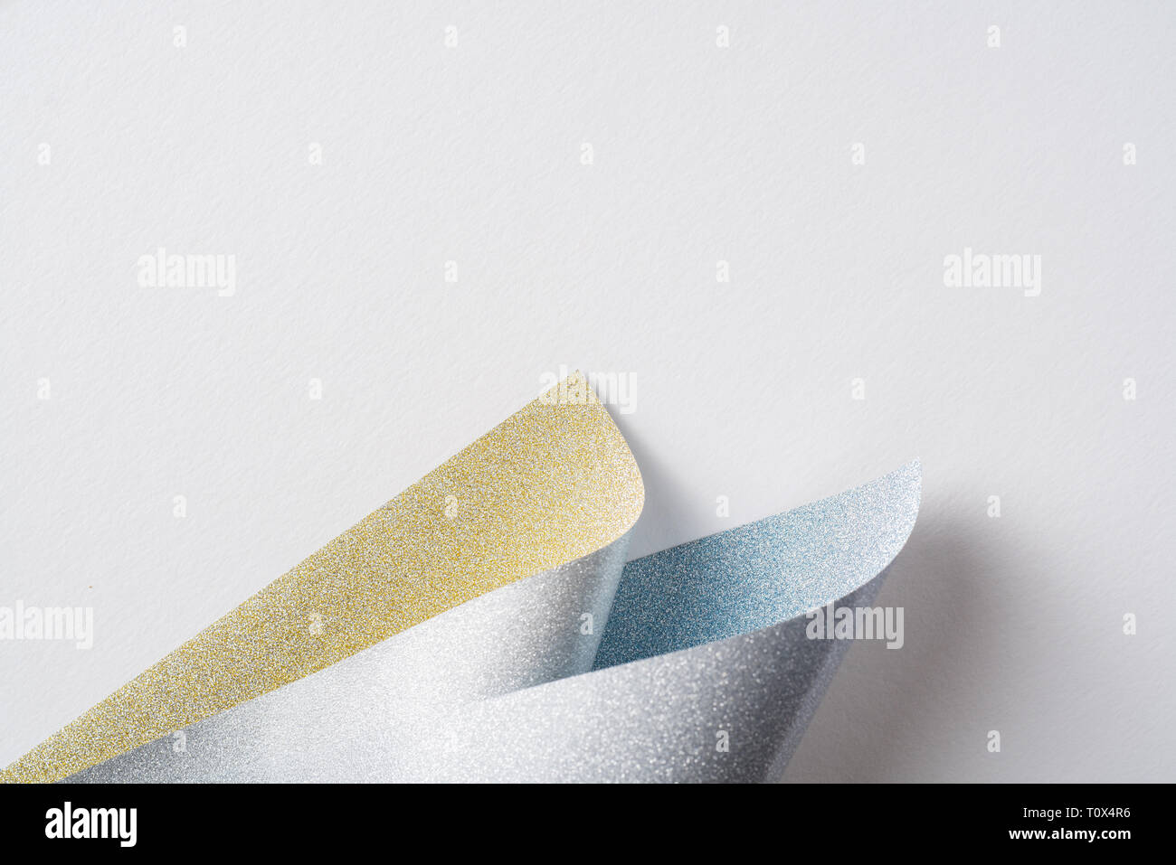 Design concept - silver and golden folded paper on golden background ...