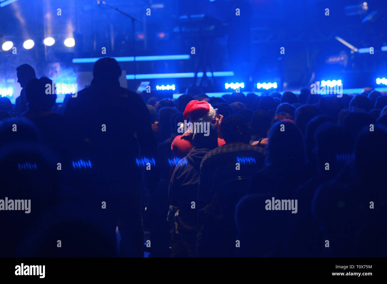 A concert fan is shown dressed up as Santa Claus at holiday concert ...