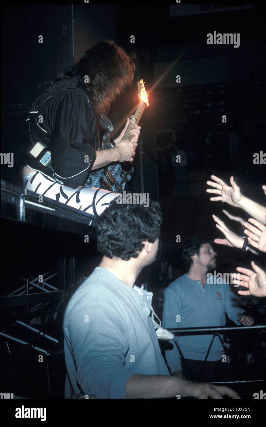 Security staff are shown working in between the performer and the crowd ...
