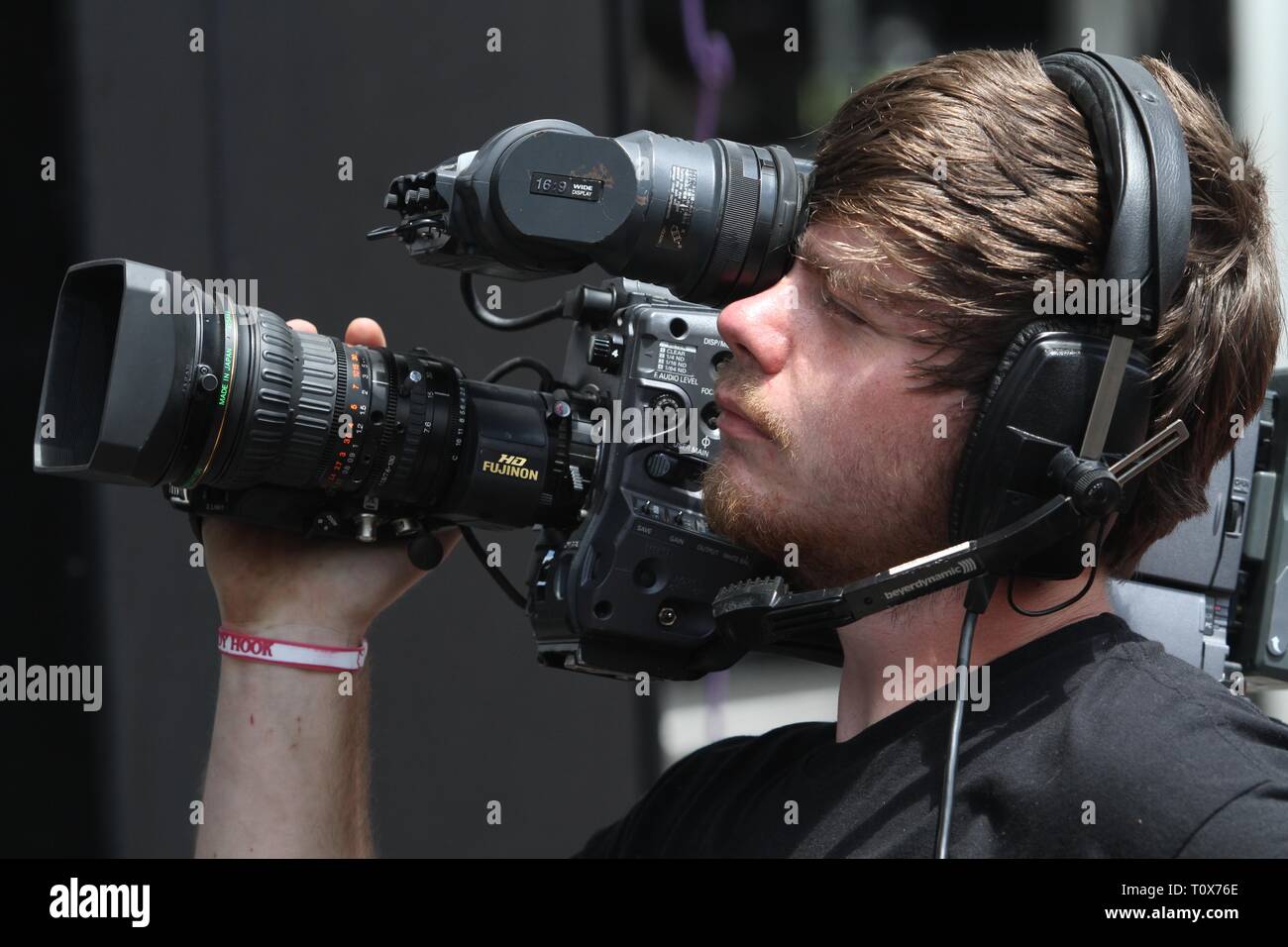 A videographer is show taping a "live" concert performance during an ...