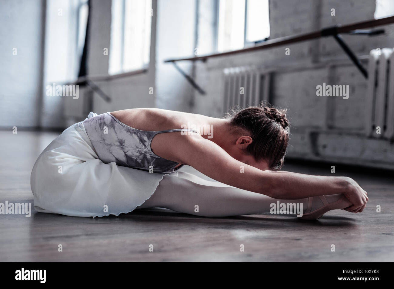 Nice good looking young woman leaning forward Stock Photo - Alamy