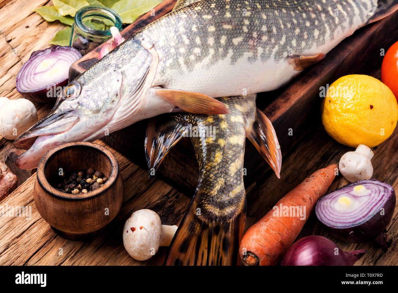 Fresh raw fish on wooden cutting board.Raw fish with spices for cooking ...