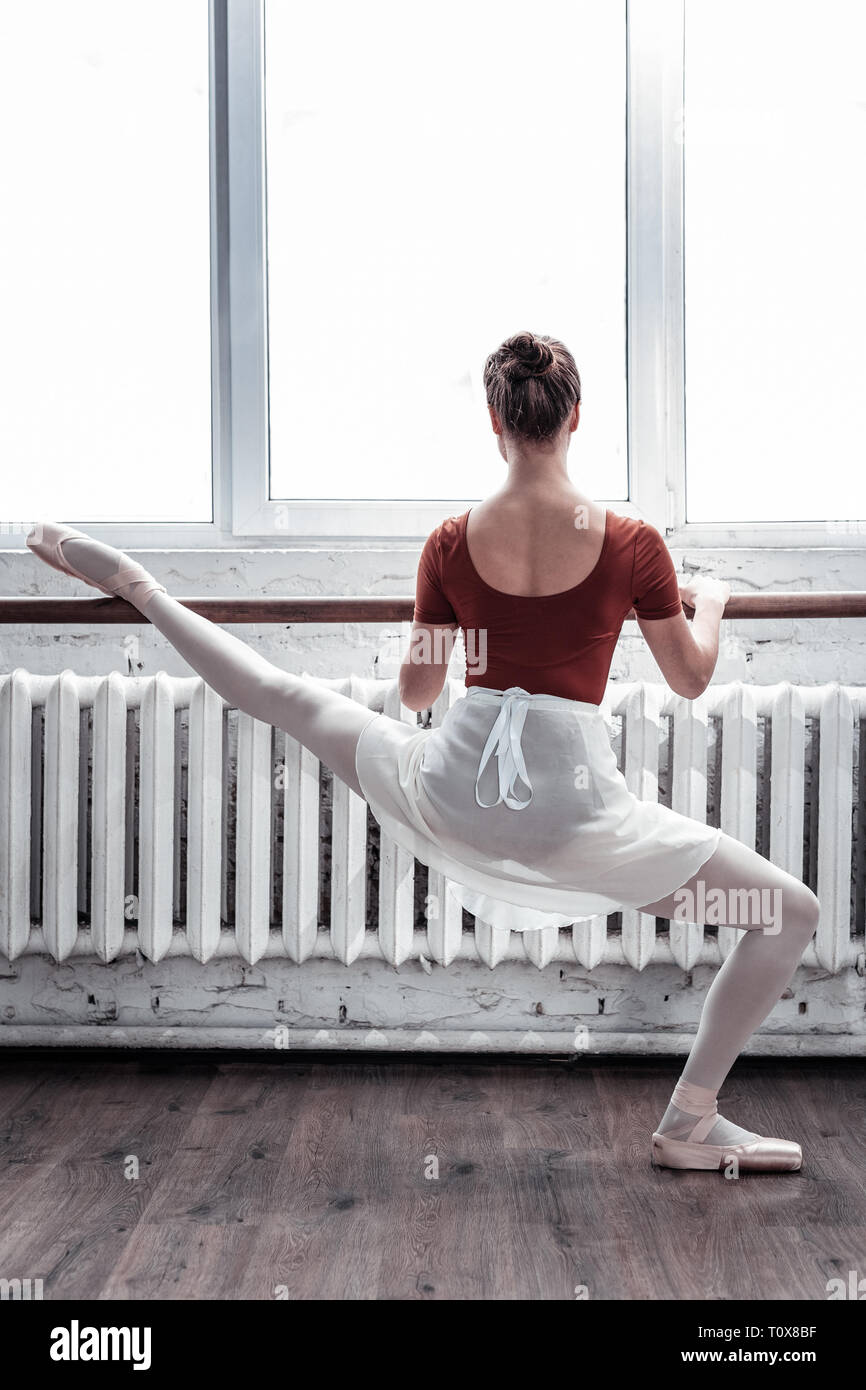 Nice beautiful ballerina standing opposite the window Stock Photo - Alamy