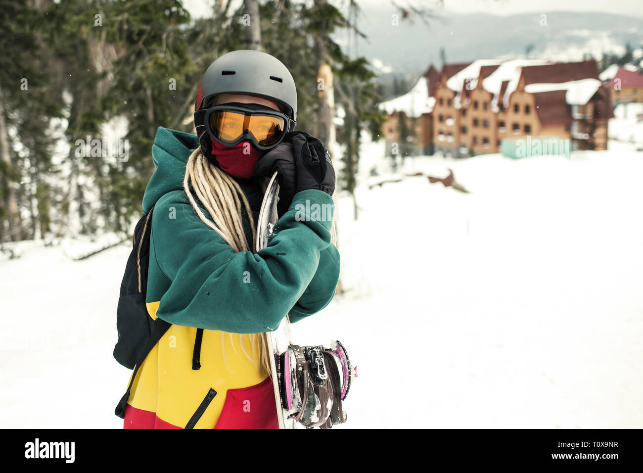 Female snowboarder standing outdoors holding a snowboard Stock Photo ...