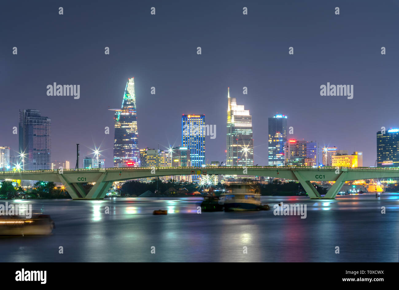 Night scene shimmering in a riverside urban area with skyscrapers ...
